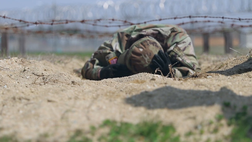 DVIDS - Video - Soldiers low crawl under barbed wire B-roll