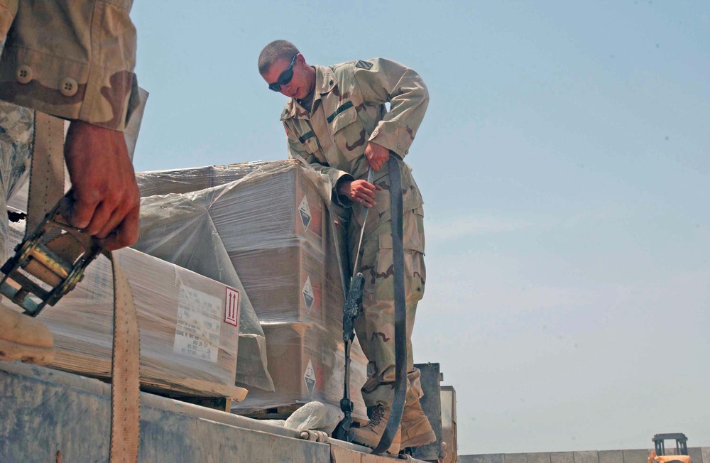 DVIDS - Images - Spc. Michael Vater tightens the strap securing a ...