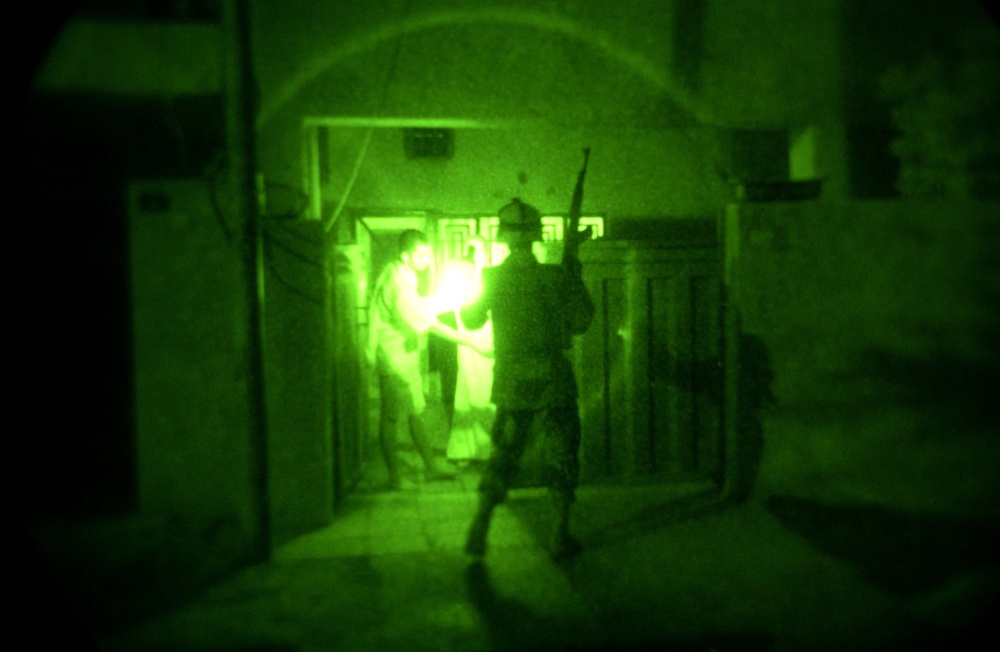 DVIDS - Images - An Iraqi Army soldier guards a raided home, [Image 3 of 4]