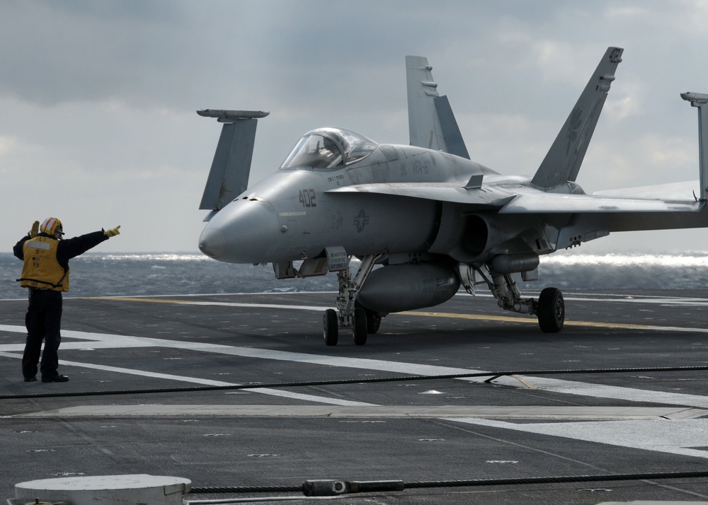 DVIDS - Images - USS George H.W. Bush sailor directs F/A-18C Hornet [Image 2 of 2]