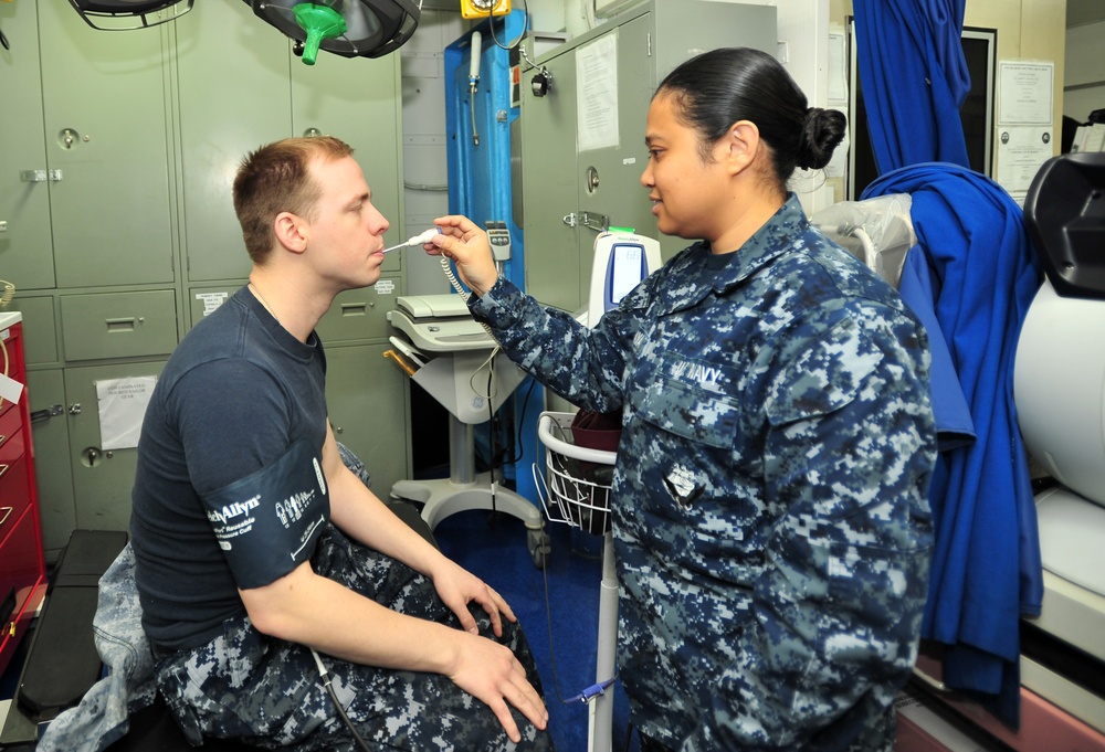 DVIDS - Images - USS George Washington sailor checks another's temperature