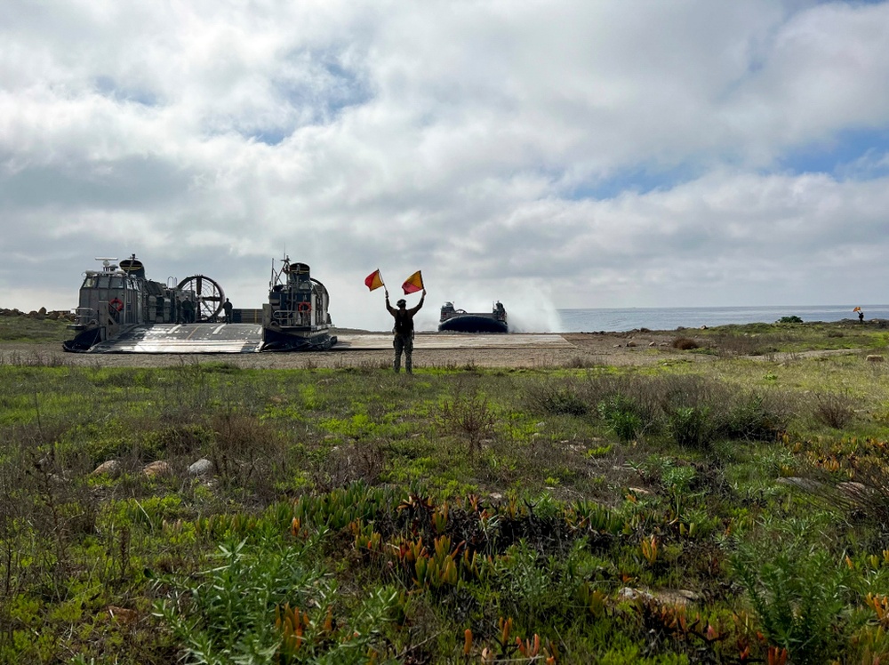 DVIDS - Images - Sailor assigned to Beach Master Unit One guides a LCAC ...