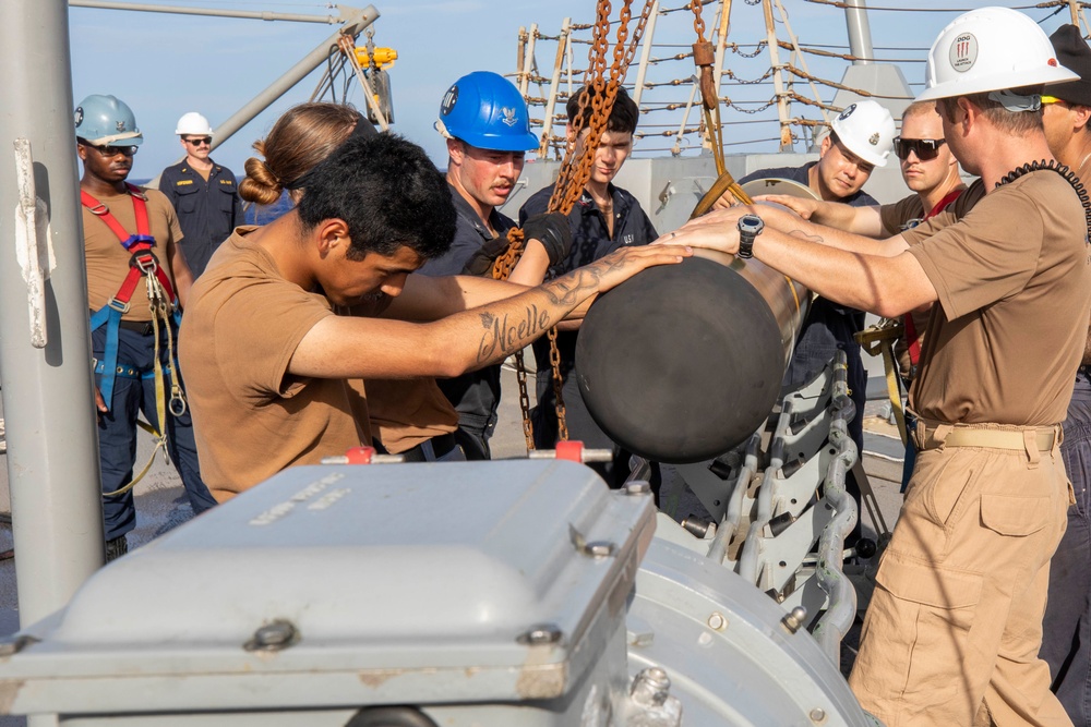 DVIDS - Images - USS Spruance Sailors load torpedoes [Image 2 of 6]