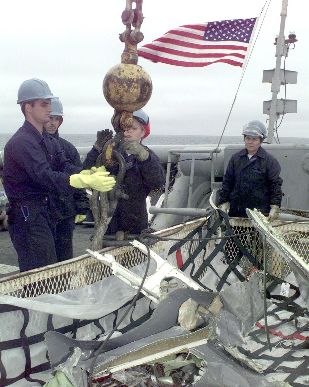 DVIDS - Images - Crew members of the USS Grapple hook up a basket of ...