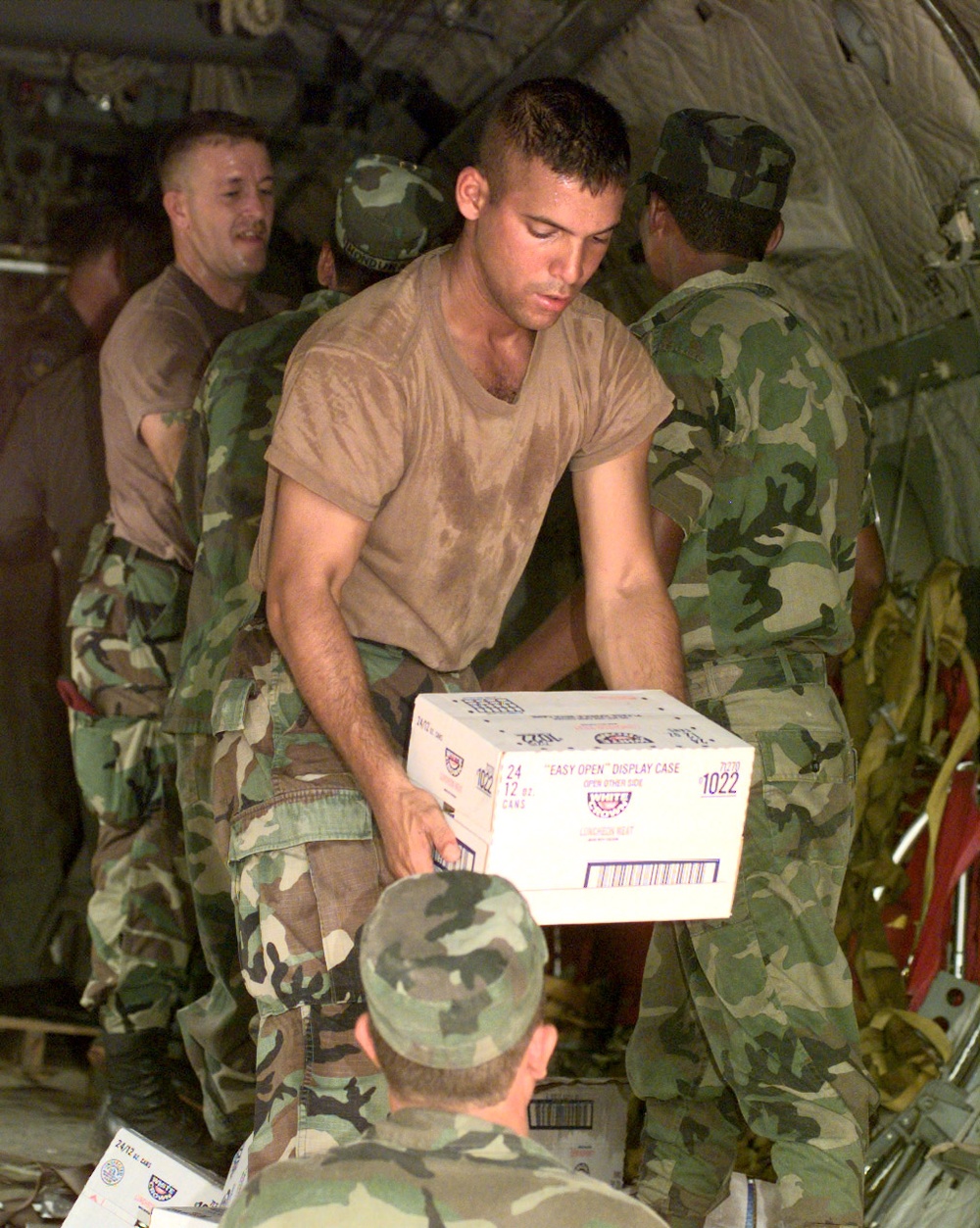 DVIDS - Images - Spc. Juan Nieves helps off load a cargo of food and ...