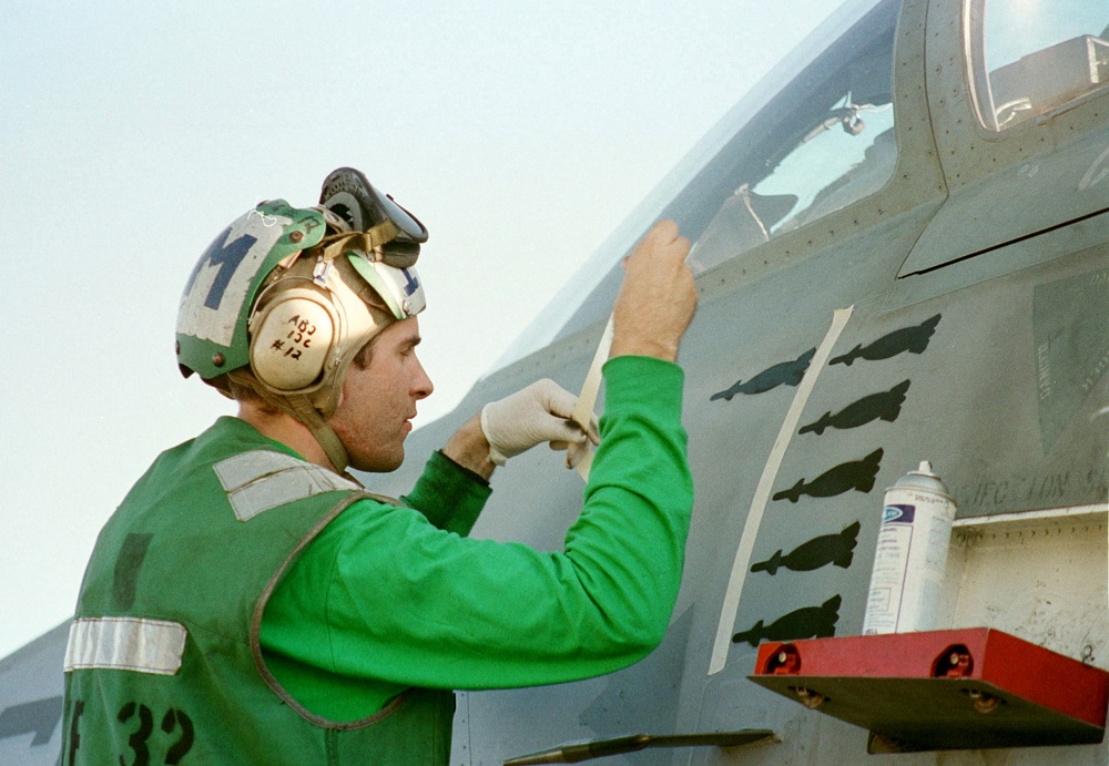 DVIDS - Images - A sailor paints an aircraft on the USS Enterprise with ...
