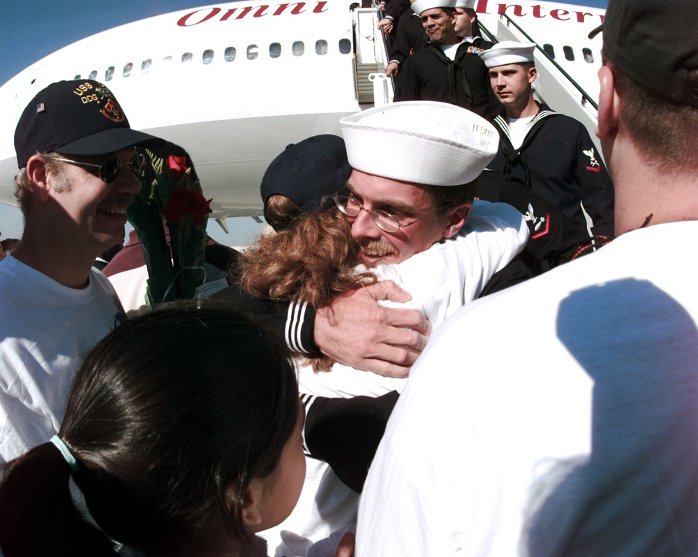 DVIDS - Images - A sailor from the USS Cole (DDG 67) is greeted by ...