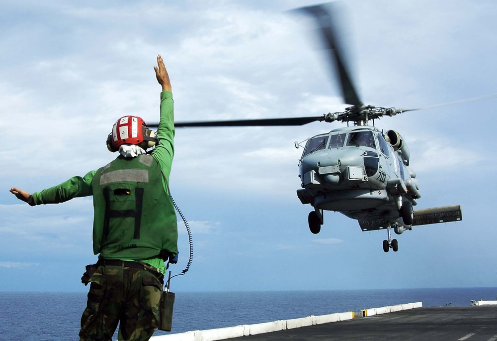 DVIDS - Images - A U.S. Navy crewman directs an SH-60B Seahawk to land on the flight deck.