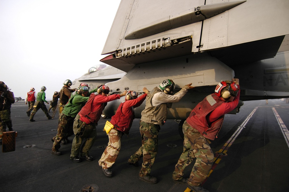 DVIDS - Images - U.S. Navy flight deck personnel push an F/A-18C ...