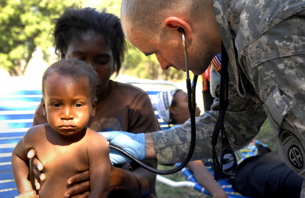 DVIDS - Images - Capt. Mark Poirier checks a baby brought to the ...