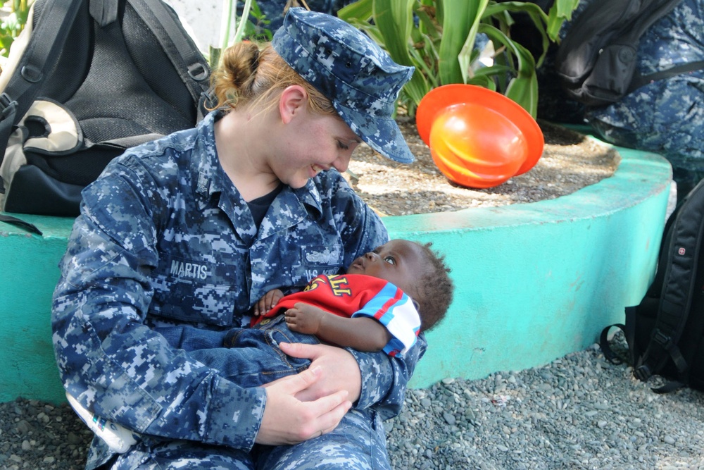 DVIDS - Images - Yeoman 2nd Class Rachel Martis cradles a Haitian child ...