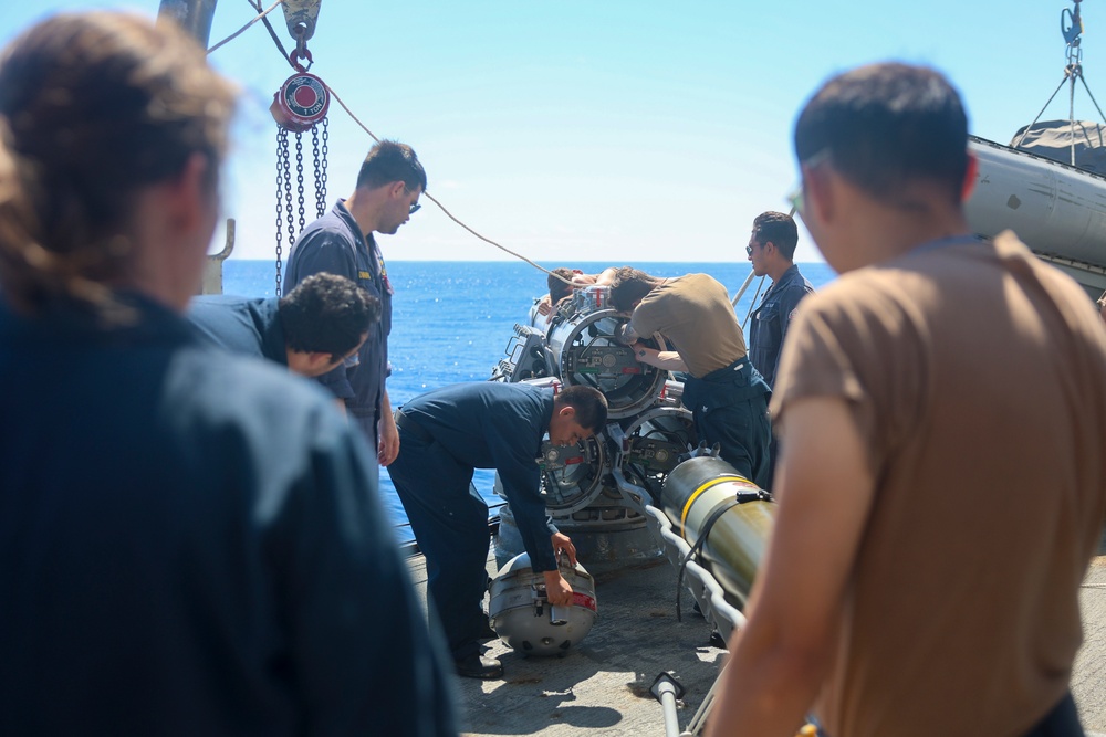 DVIDS - Images - USS Bulkeley Sailors load a MK54 torpedo into a torpedo tube. [Image 2 of 3]